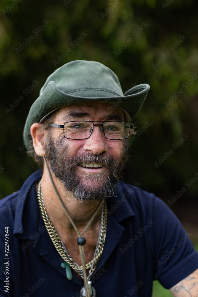 head and shoulders of unkempt man smiling and wearing a hat Stock Photo ...
