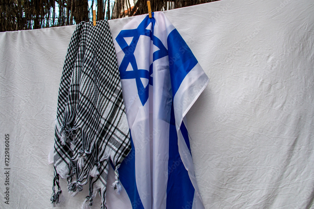Israel flag and Palestinian scarf together lying on a rope to dry after ...