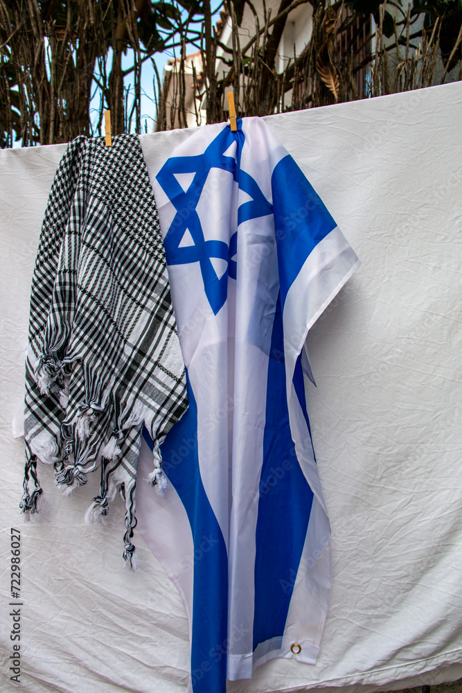 Israel flag and Palestinian scarf together lying on a rope to dry after ...