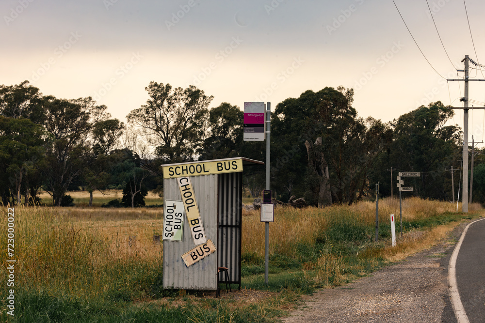 Rural bus stop on the roadside in country Victoria covered in signs ...