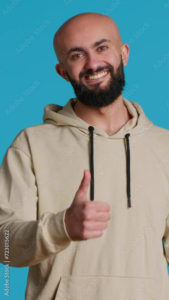 Vertical Video Middle eastern person does thumbs up sign on camera ... Vertical Video Middle eastern person does thumbs up sign on camera ...