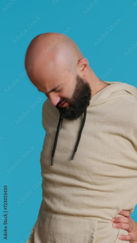 Vertical Video Middle eastern model dealing with lower back pain ...