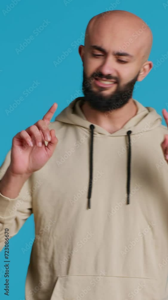 Vertical Video Arab male model doing no symbol on blue backdrop ... Vertical Video Arab male model doing no symbol on blue backdrop ...