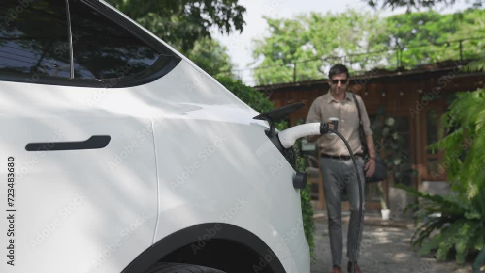 Slow motion man and sustainable urban commute with EV electric car ...