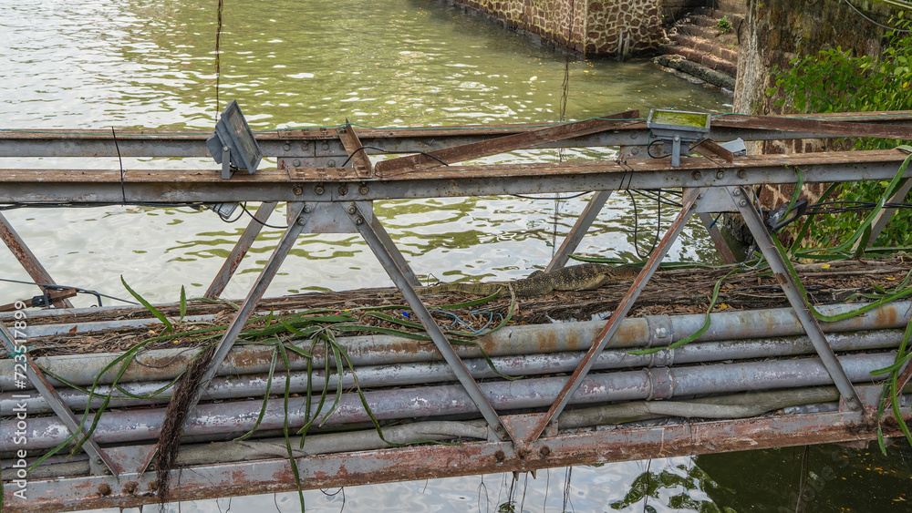 Foto de Metal cables are laid on an old rusty technological bridge over ...