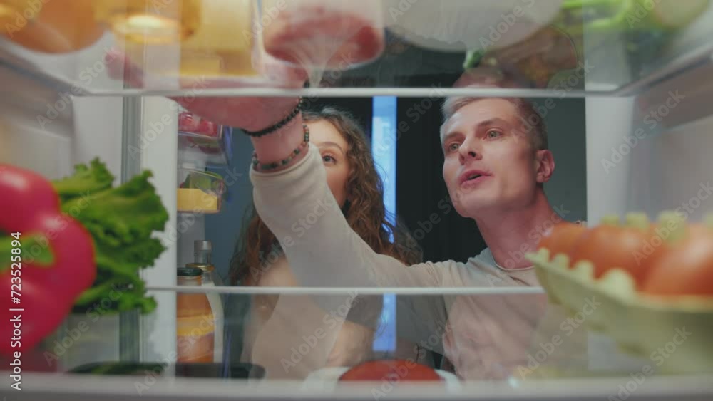 Vidéo Stock Man and Woman Opening Fridge Door with Healthy Food and ...