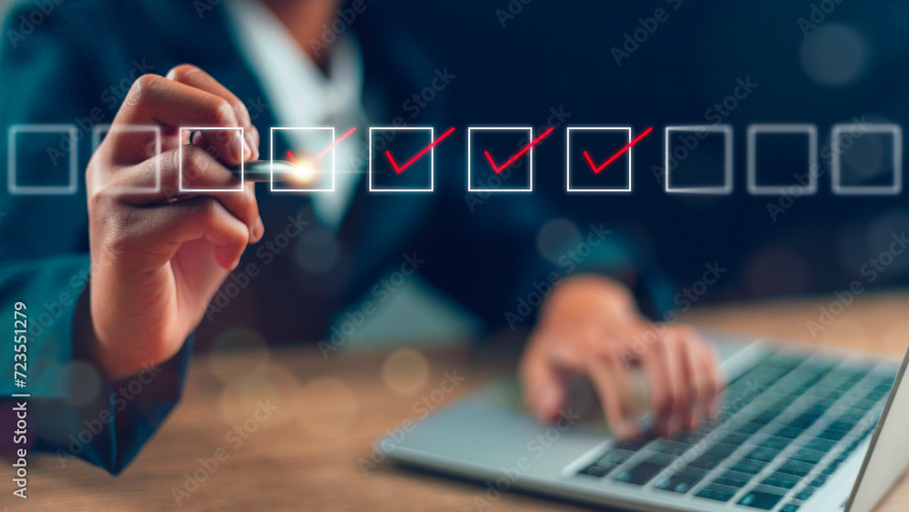 Businesswomen use pens to tick the correct sign mark in the checkbox ...