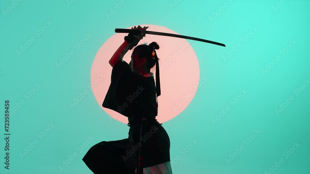 Young asian woman in a traditional kimono removing the katana from the ...