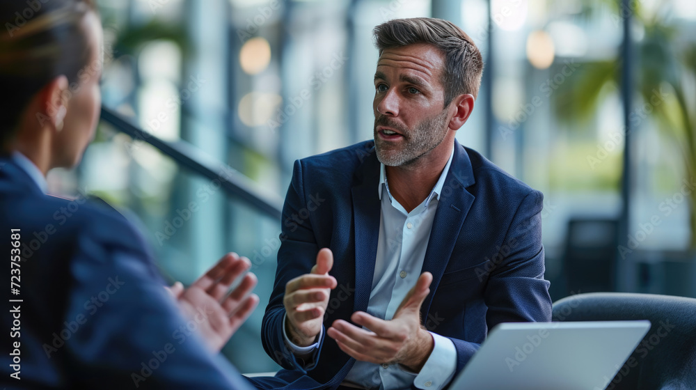 Man in a conversation, gesturing with his hands while speaking to an ...