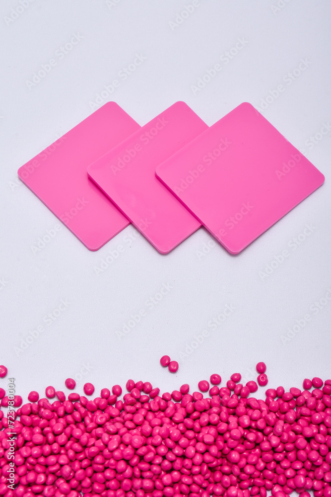pink masterbatch granules with color chips as an example of the color ...