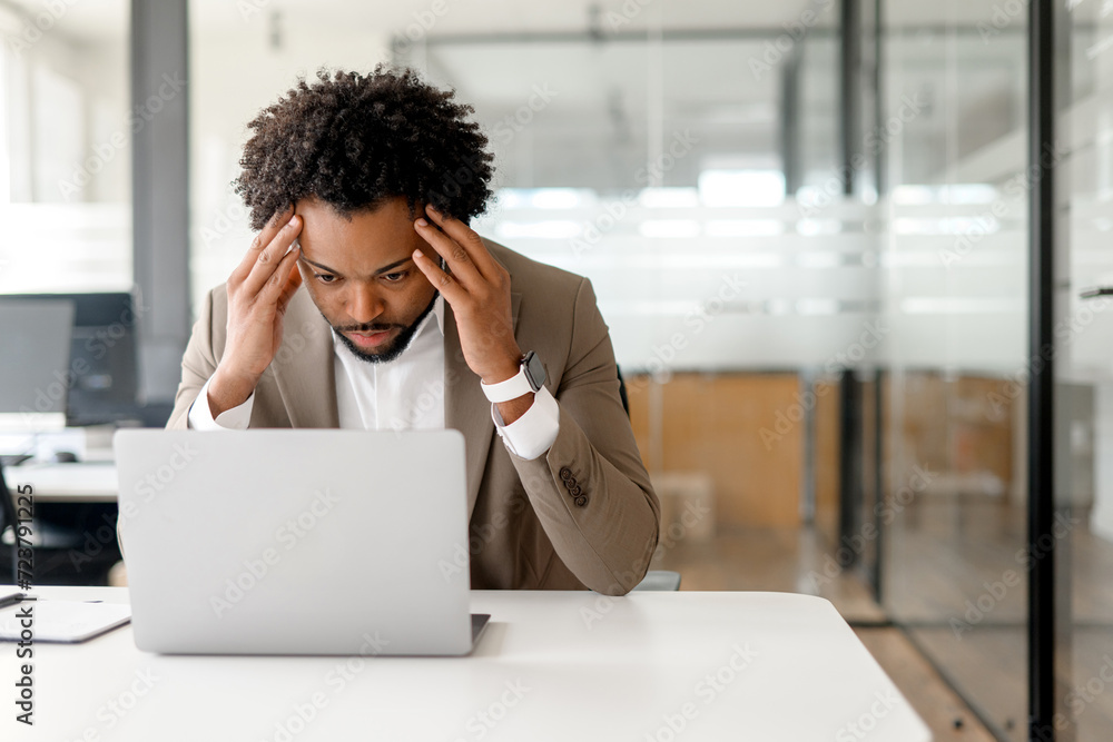 Stressed African-American businessman shows signs of concern as he ...