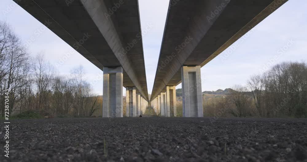 Highway bridge underpass structure with concrete columns on a blue sky ...