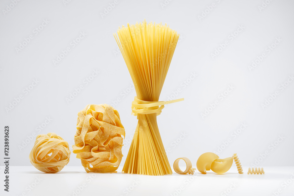 Various types of dry pasta on a white background. Bunch of Spaghetti ...