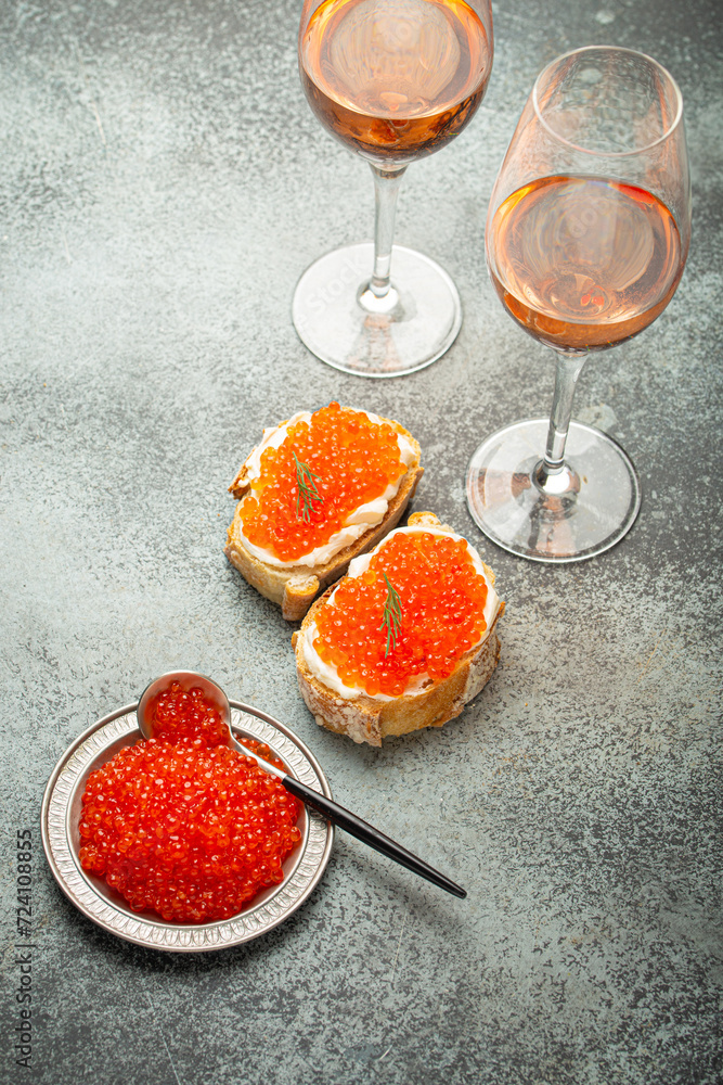 Small metal plate with red salmon caviar, two caviar toasts canapé, two ...