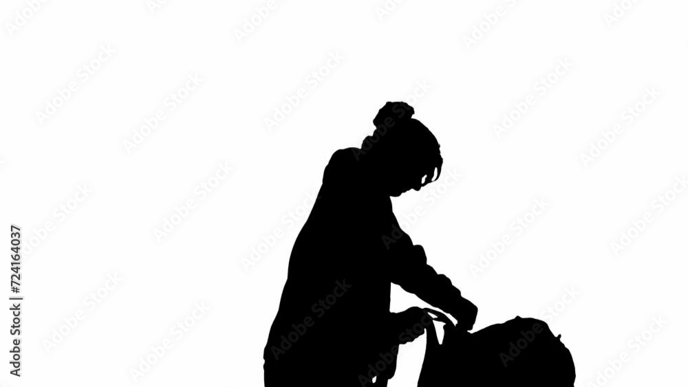 Black silhouette of a male traveler removing a backpack from his back ...