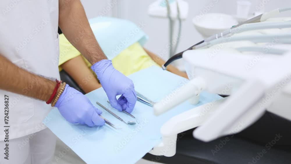 Male dentist arranging dental tools in modern clinic. Slow motion of an ...