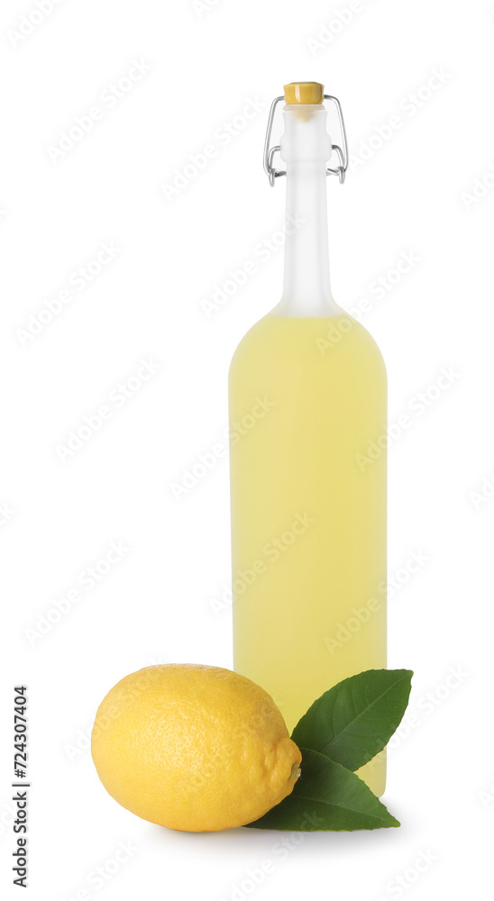 Bottle of tasty limoncello liqueur, lemon and green leaves isolated on ...