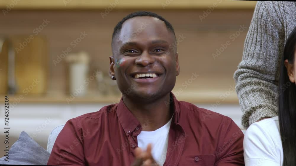 Vidéo Stock A handsome dark-skinned young male fan in close-up watches ...