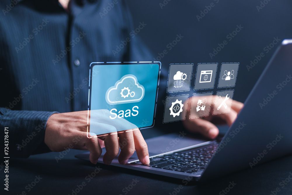 SaaS (software as a service) concept, Person use laptop with virtual screen of SaaS icons for ...