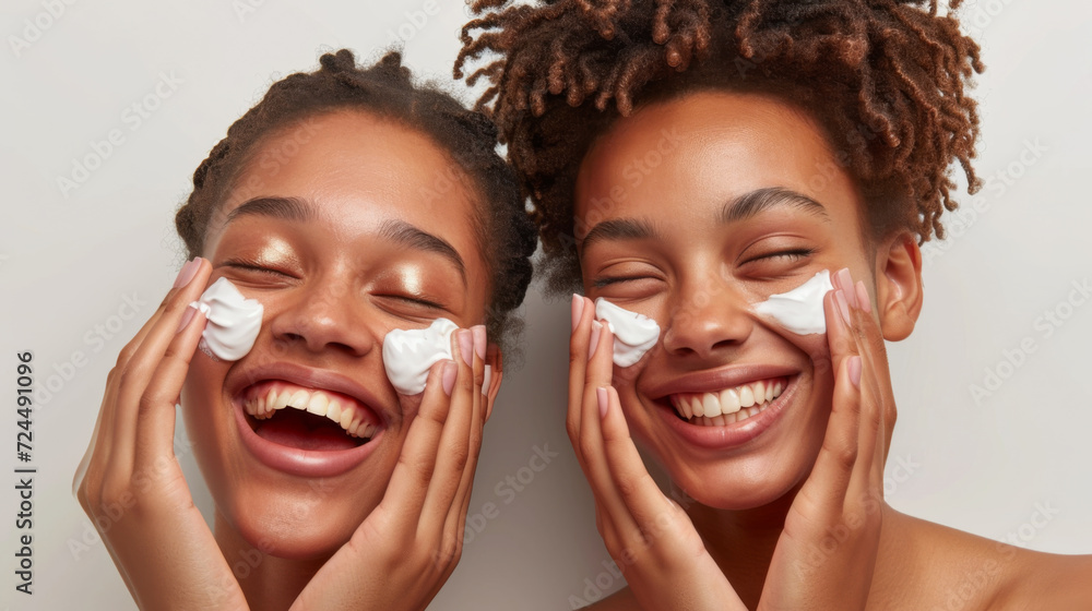 two joyful individuals with radiant smiles, playfully applying facial ...