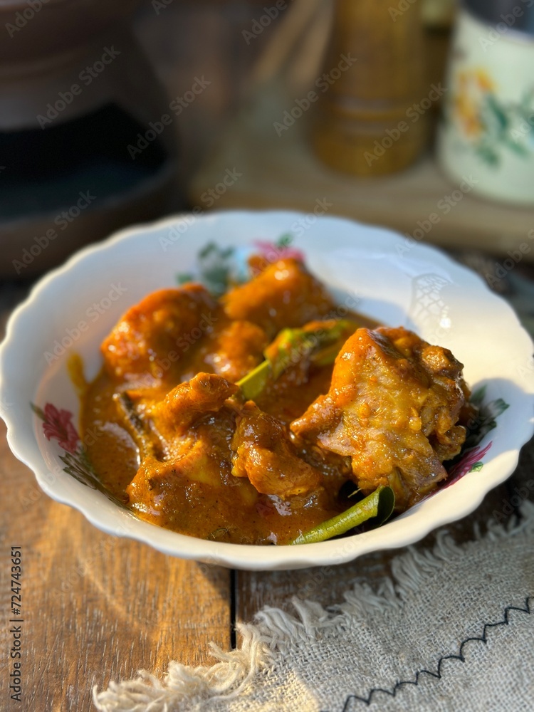 Closeup Rendang ayam or chicken rendang on Wooden plate. Rendang ayam ...