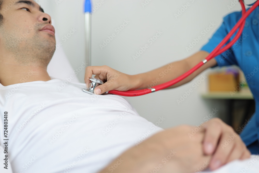 Doctor visiting a male patient on a hospital bed, Examine the patient ...