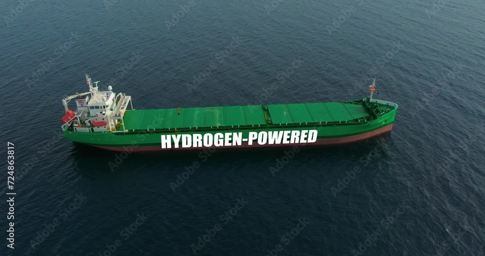 A large green ship in the blue ocean is carrying important cargo. The ...