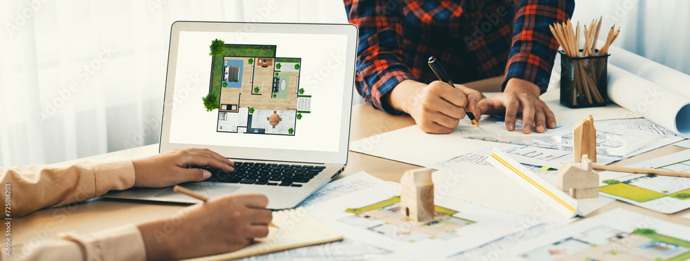 Professional architect represented ECO house displayed on laptop to ...