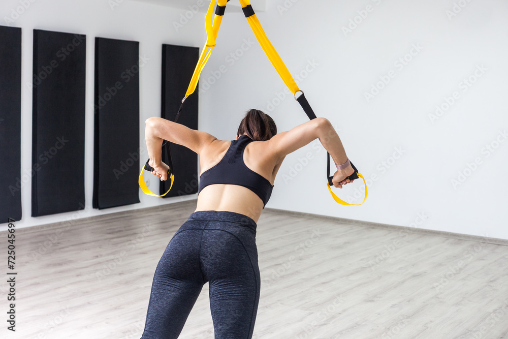 Side view portrait of strong woman wearing black sportswear doing push ...