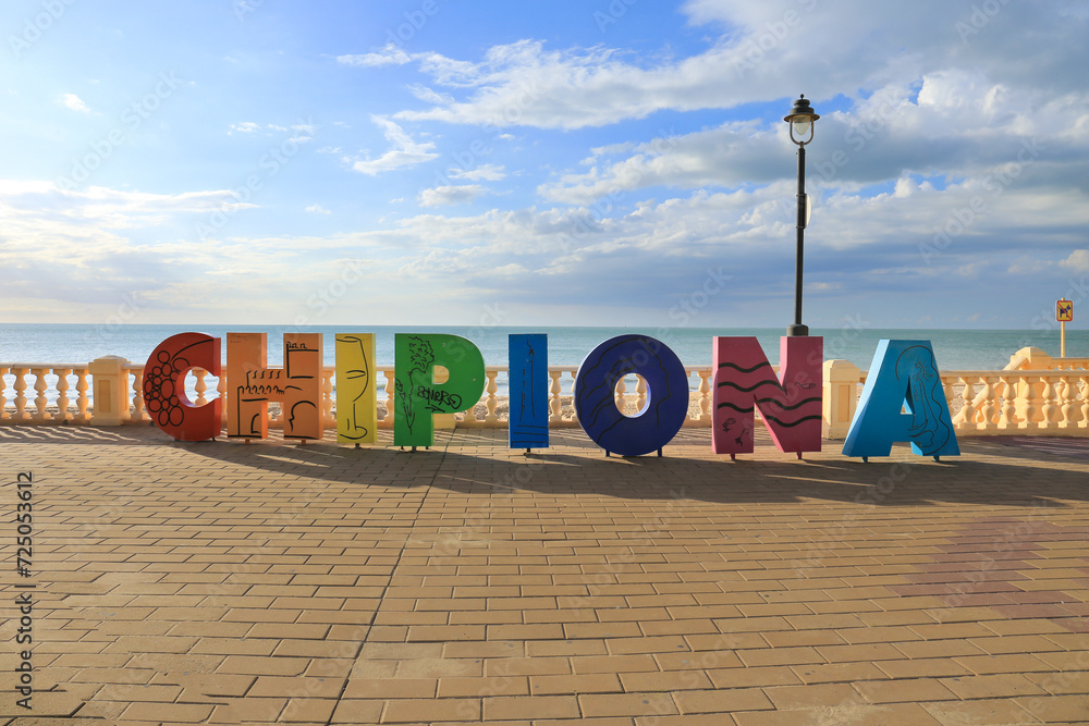 Colorful letters forming the name of Chipiona town in the promenade ...