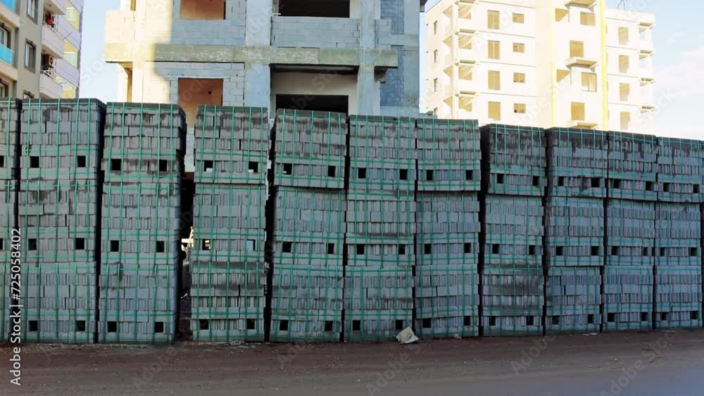 Construction site with pumice blocks on pallets showing building ...