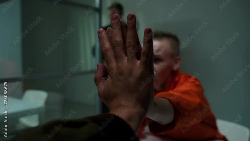 Sad female inmate telling to husband how much she misses him, holding ...
