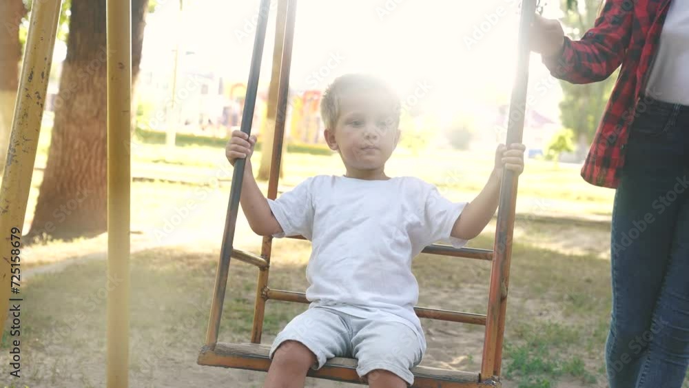 Stockvideo little boy swings on a swing. concept of a happy childhood ...