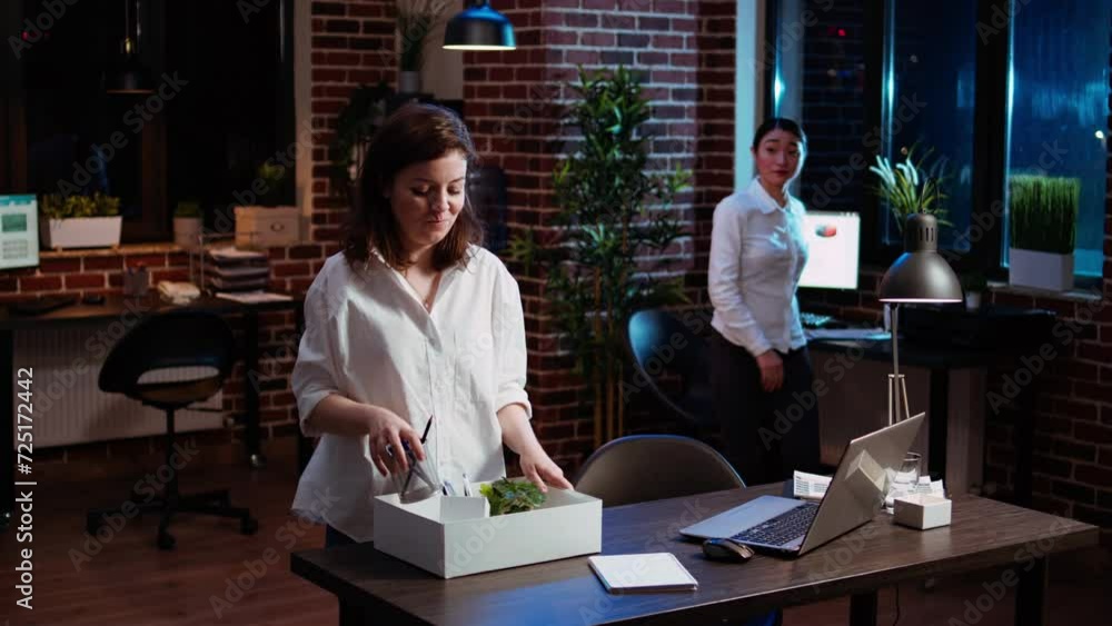 Woman packing desk belongings, excited to change offices after finally ...