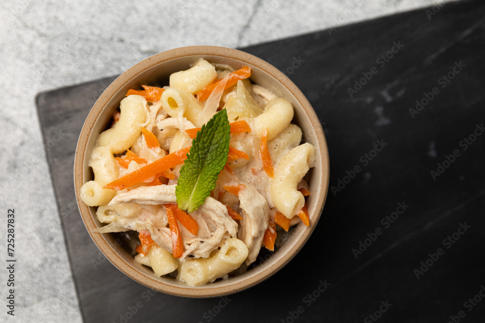 Bowl of sopas soup with chicken, macaroni, cabbage, carrots and ...