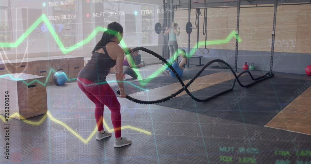 Image of data on graph over caucasian woman cross training with battle ...