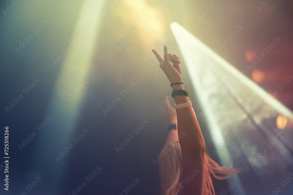 Dark, concert and excited woman with arms raised cheering for fun ...