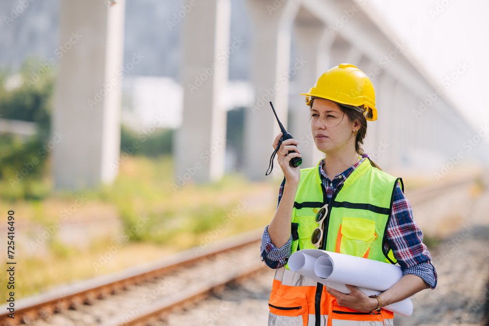 Engineer caucasian women railway tracks service team working on site ...