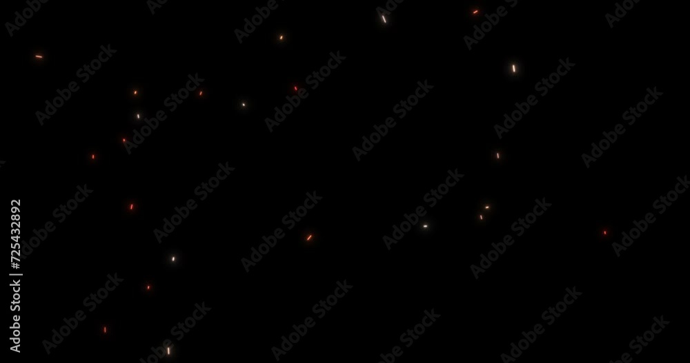 Sparks from the fire swarming in the wind. Flying with swirling red and ...
