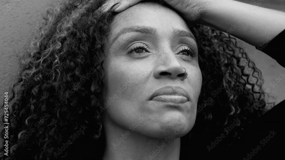 Desperate South American black woman gazing in the distance pondering ...