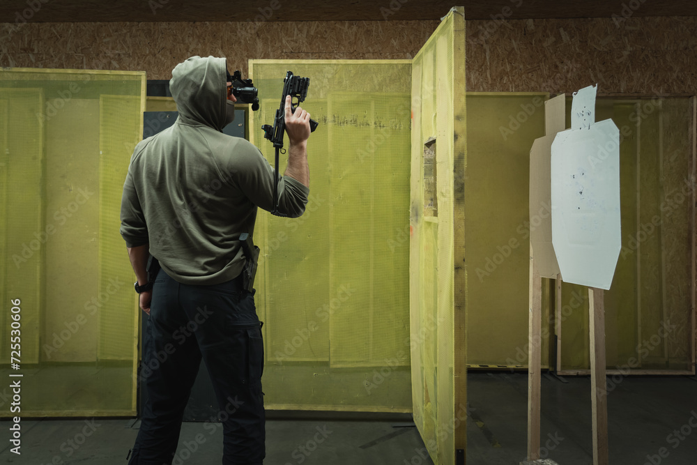 Tactical shooting from modern firearms with night vision at a shooting ...