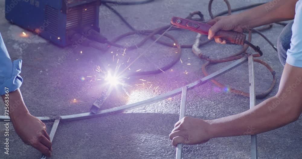 Man cuts rusty metal beam using round turbine. Blacksmith performing ...