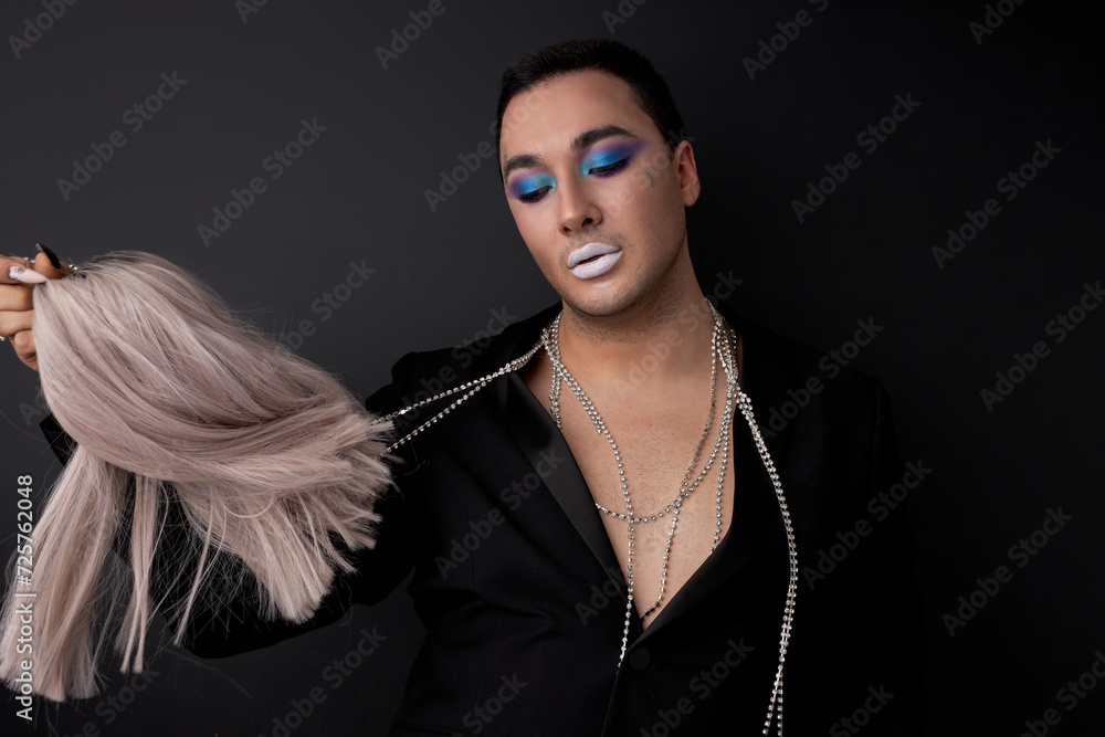 self-confident transvestite or gay take off the wig from head, male ...