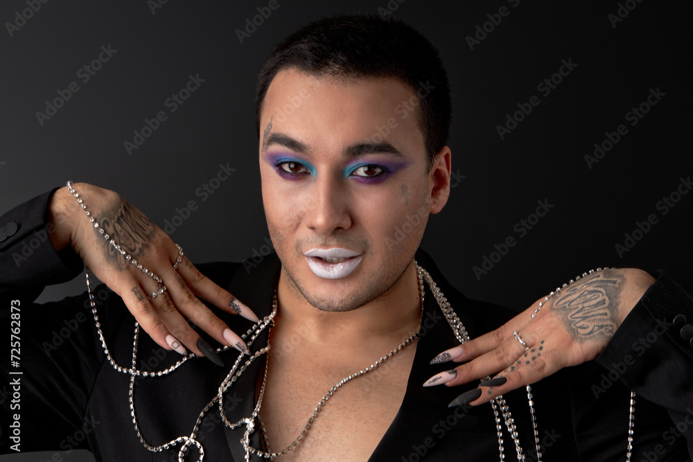 Male makeup look. Portrait of cool brunette man in black wear, with ...