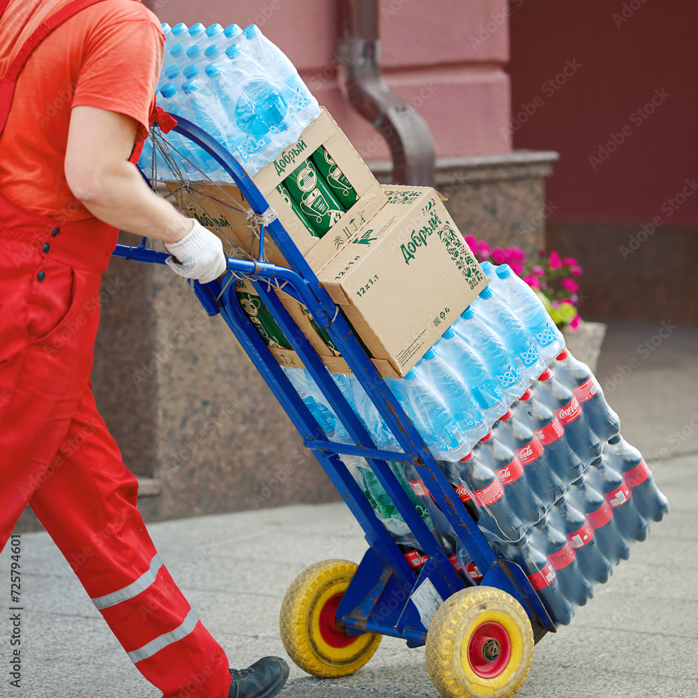 Minsk, Belarus. Jul 5, 2023. Worker pushing dolley full off bottles of ...
