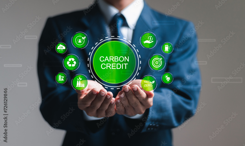 Carbon credit concept. Businessman holding virtual carbon credit icons ...