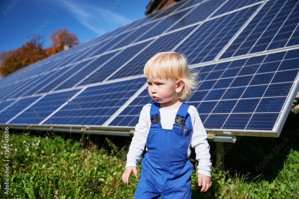 Little cute boy wondering how does solar panel work. Adorable blond kid ...