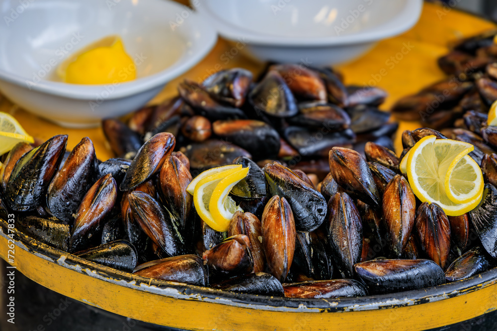 Fresh raw mussels with lemon on a platter waiting to be stuffed for ...