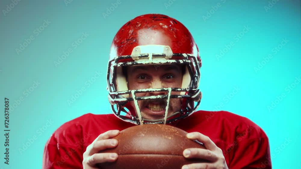 Emotional man, American football player in helmet and red uniform, with ...