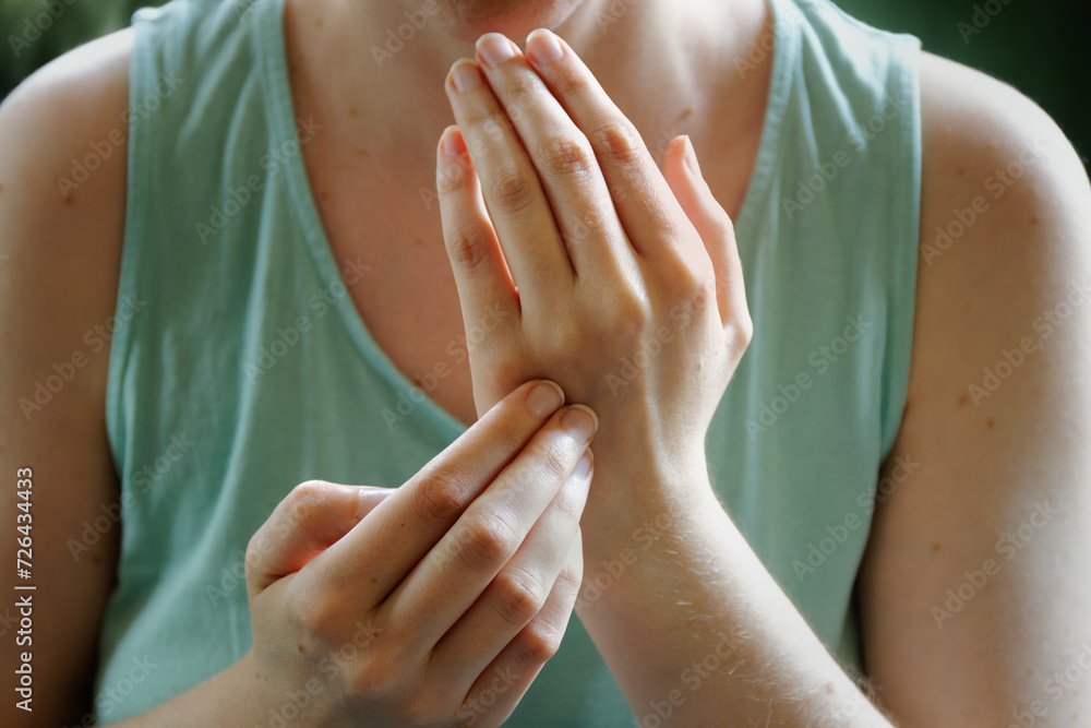 Person practicing EFT. Female tapping gamut point, hands close-up view ...